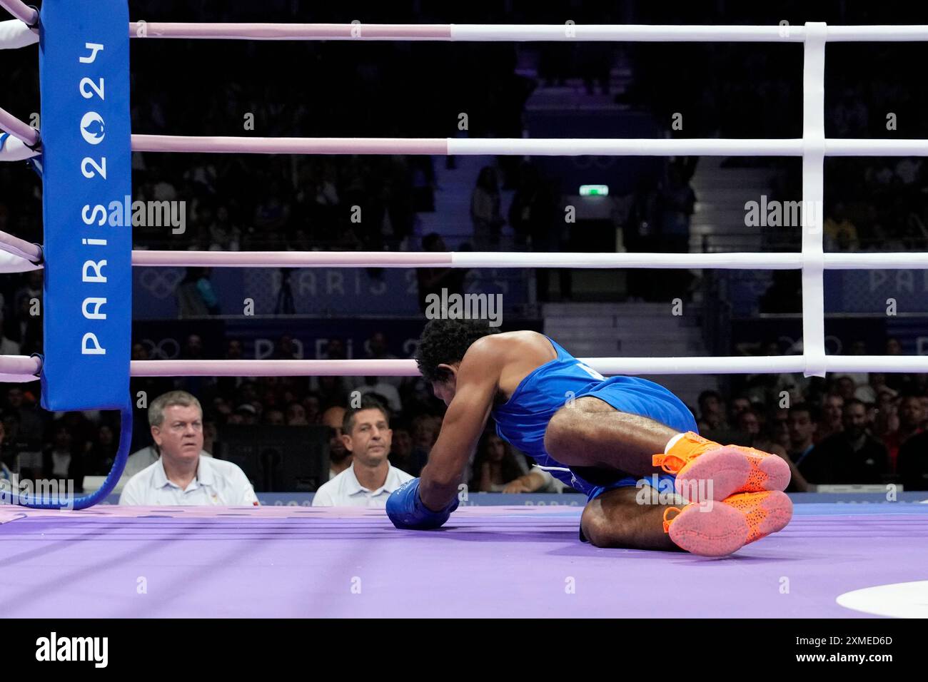 Papua New Guinea's John Ume lies on the mat after he was knocked down ...