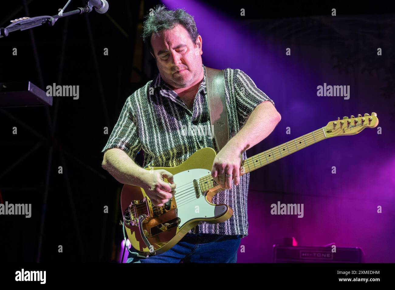 Lee Harris play the guitar during the live performs with Nick Mason ...