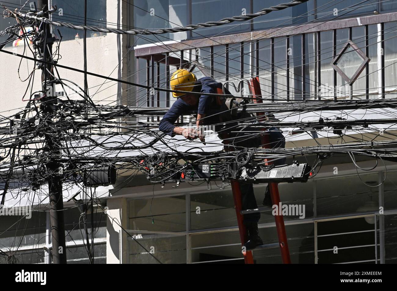 Electrician on a ladder working on the massive wiring in the Roma ...