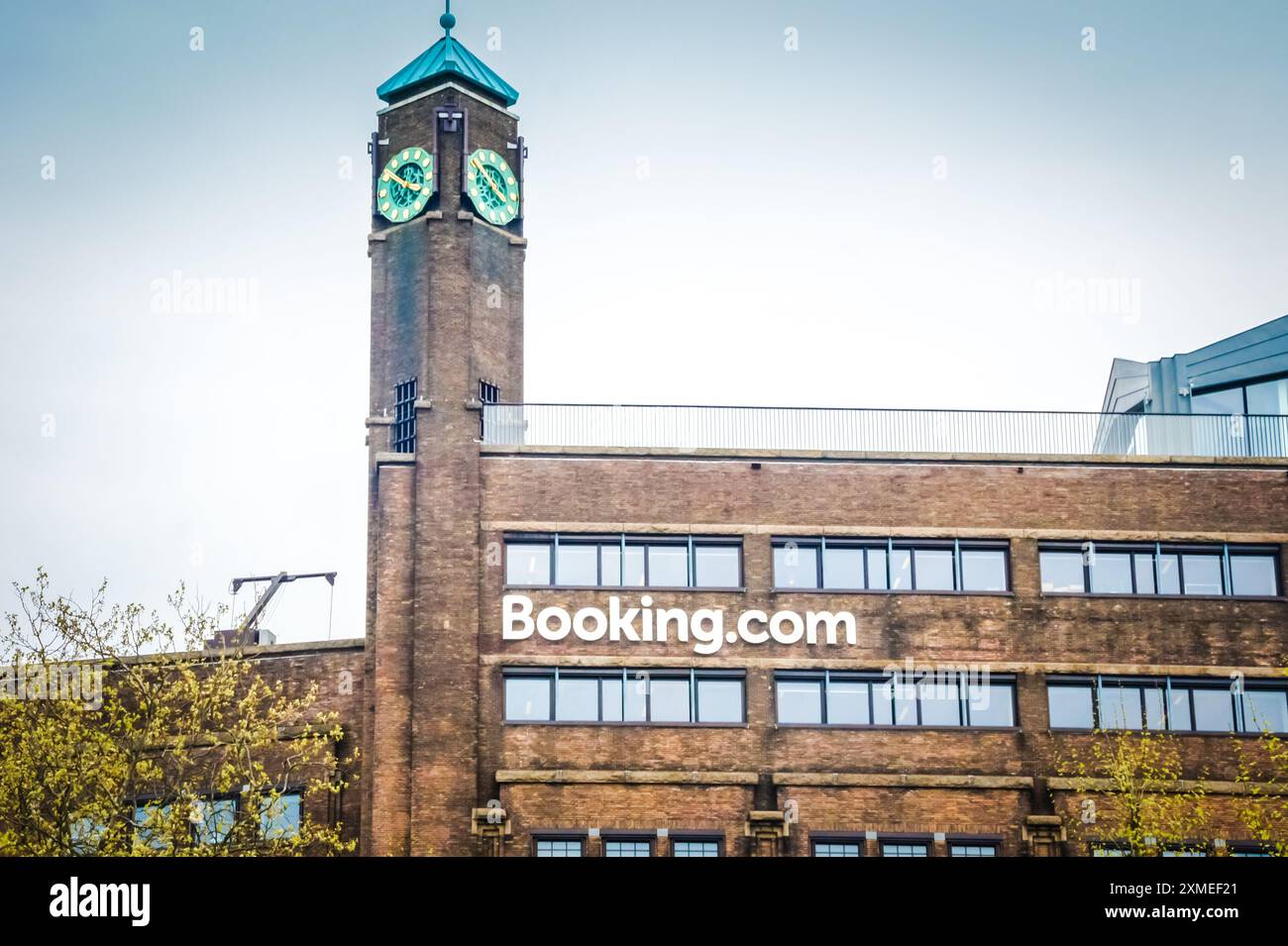 In Amsterdam, the modern, glass facade of the Booking.com headquarters ...