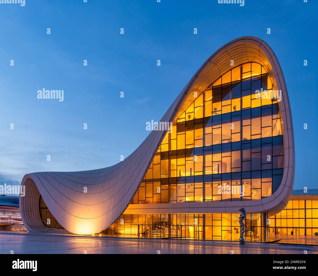 The Heydar Aliyev Centre in Baku, Azerbaijan, glows warmly in the night with its unique, flowing ...