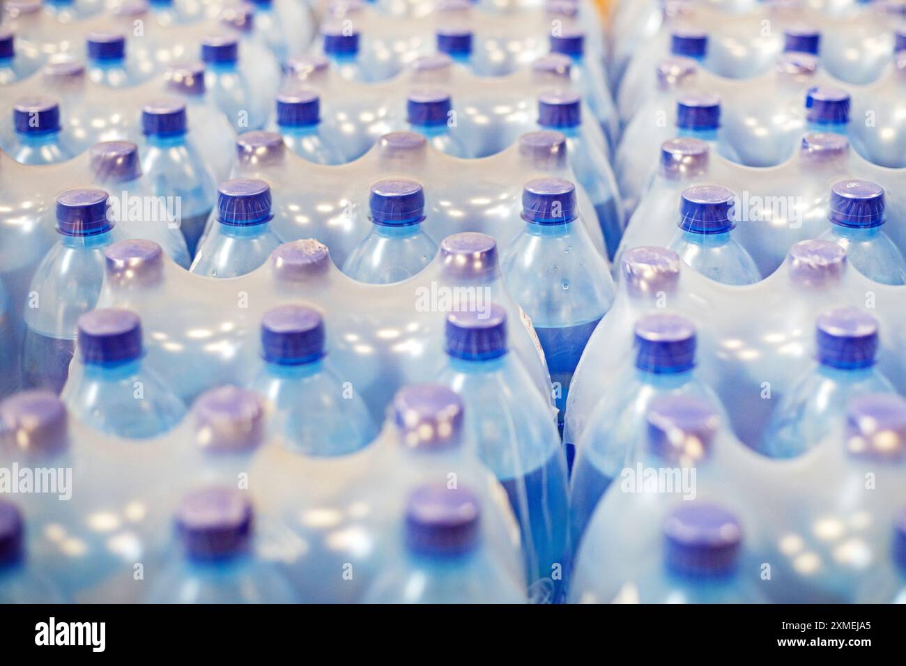 drinking water packaged in plastic containers on the shelves in the ...