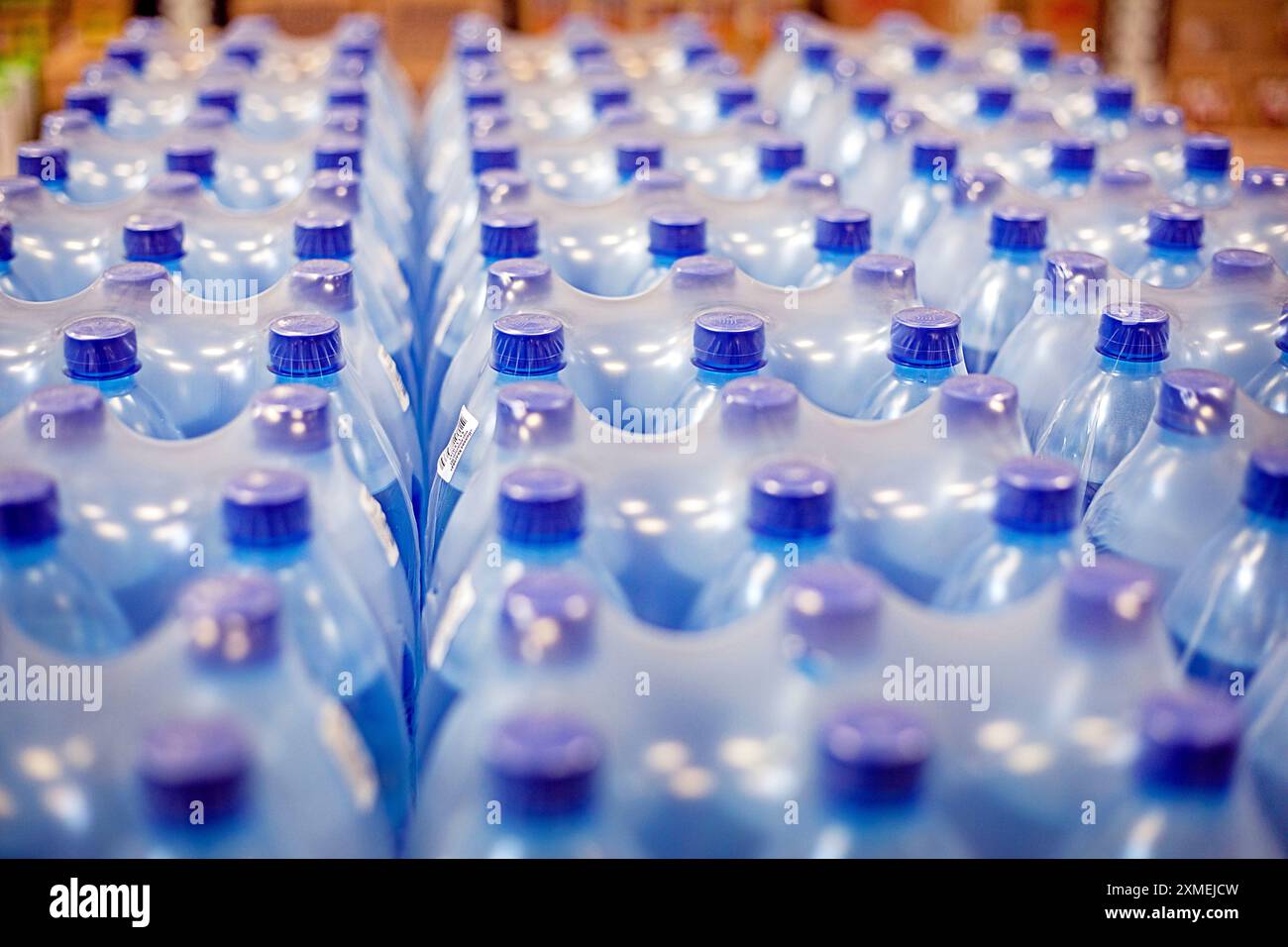 drinking water packaged in plastic containers on the shelves in the ...
