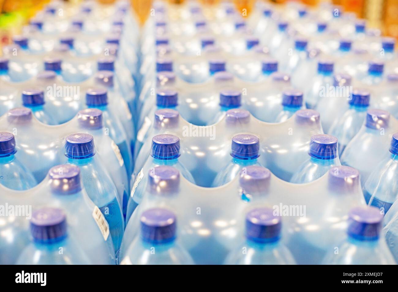 carbonated drinking water packaged in plastic containers with blue lids ...
