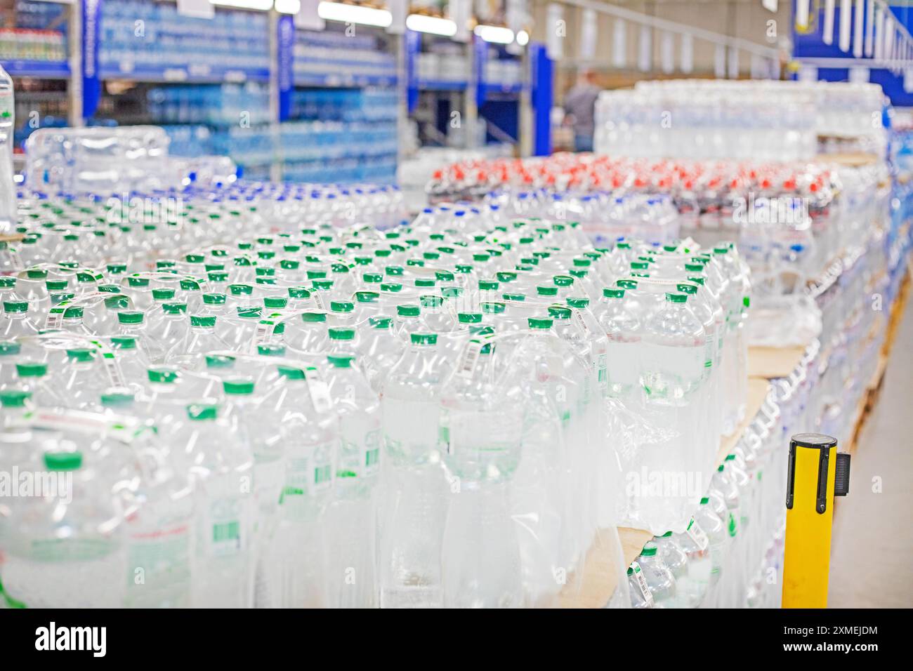 drinking water packaged in plastic containers with lids on the shelves ...