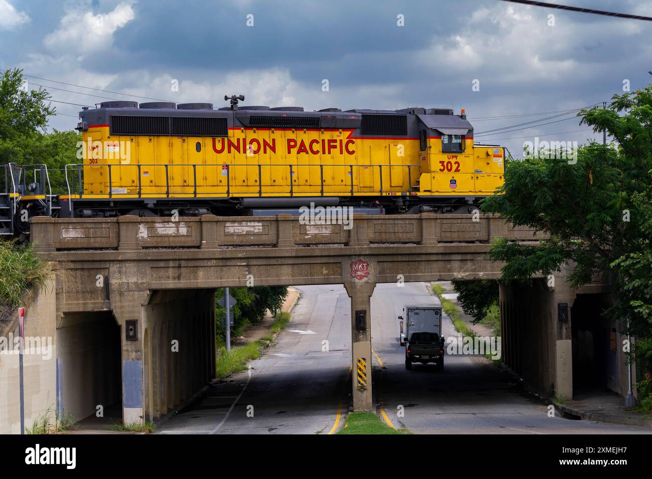 Union Pacific locomotive crossing old MKT railroad bridge working rail ...