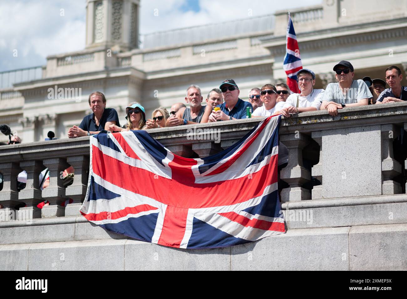 Tommy Robinson supporters hold a British flag during the rally in ...