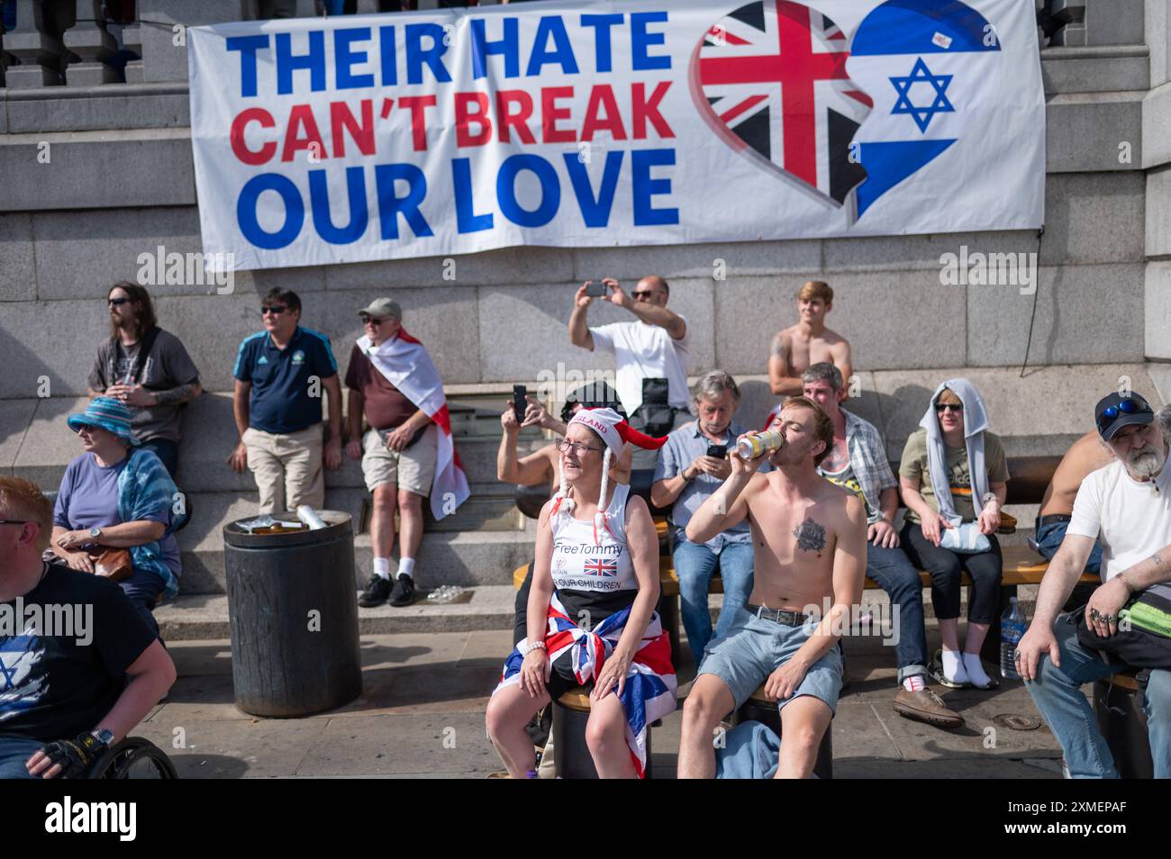 London, UK. 27th July, 2024. Demonstrators listen to the speeches ...