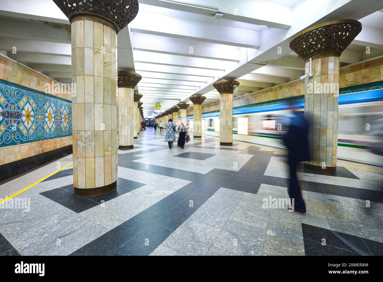 View of the station platform with a departing train. At the Pakhtakor ...