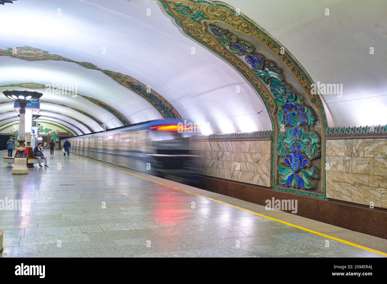 A view of the platform with curved ceiling, glass light column and ...