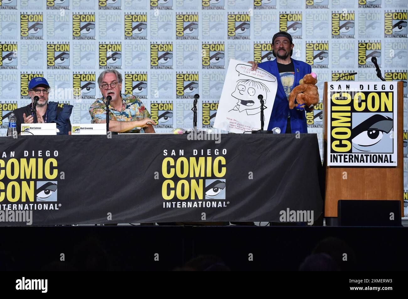 Matt Selman, from left, Matt Groening, and Kevin Smith attend a panel ...