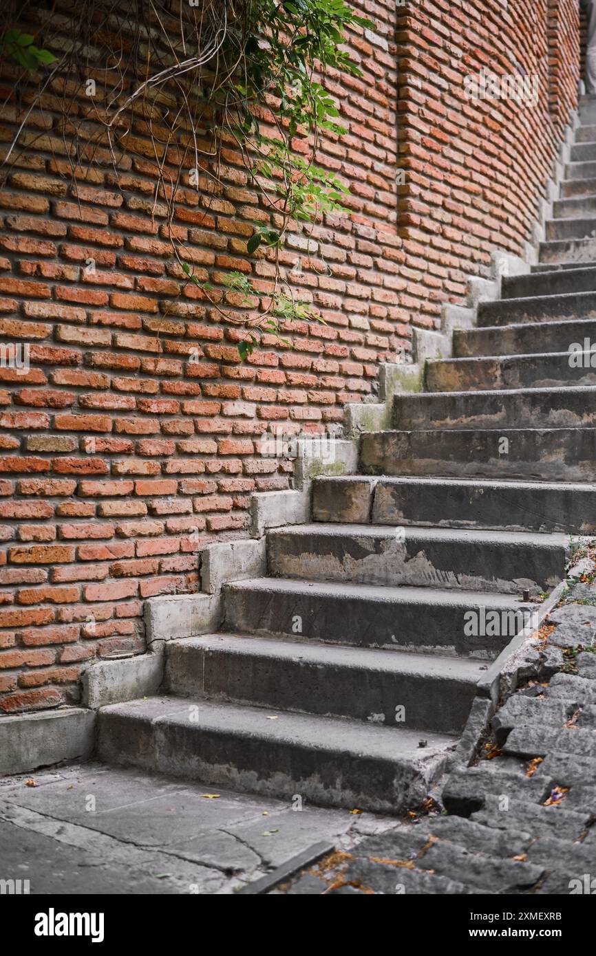 stairs by a brick wall on a steep street in the old town, time for ...