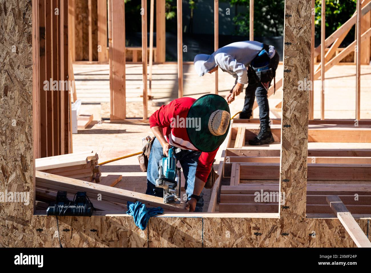 Construction work crew building a new house in a residential ...
