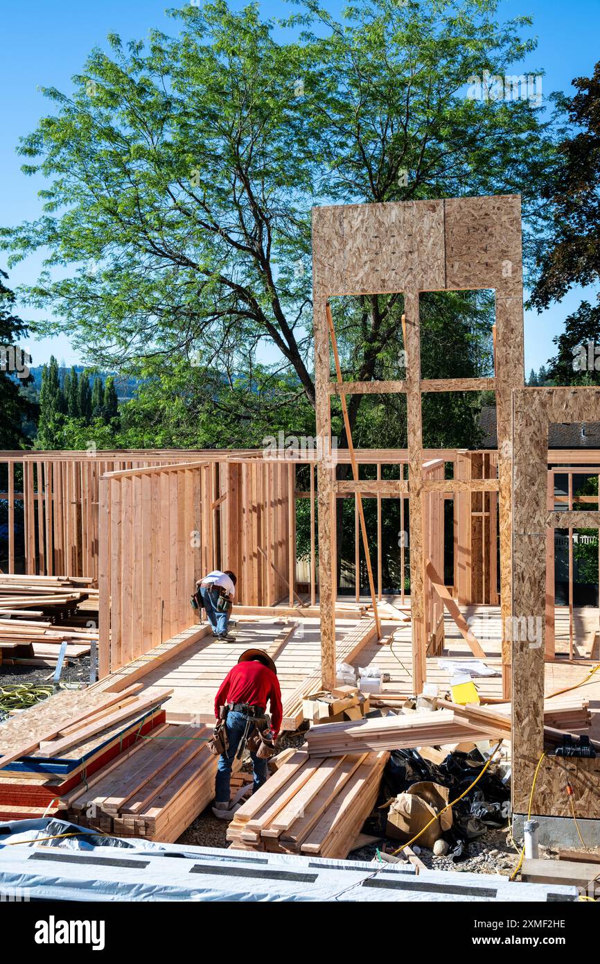 Construction work crew building a new house in a residential ...