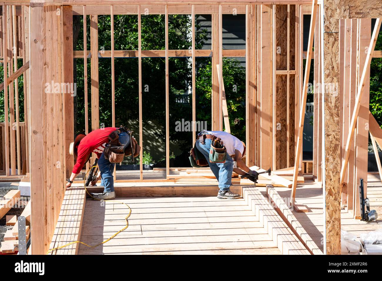 Construction work crew building a new house in a residential ...