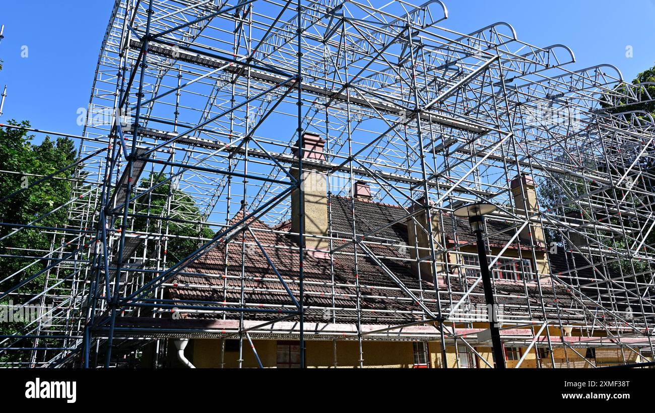 A house undergoing renovation is surrounded by an extensive scaffolding ...