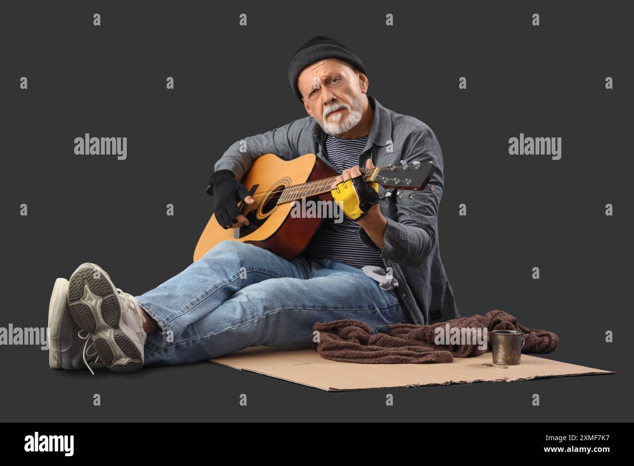 Mature homeless man playing guitar on dark background Stock Photo - Alamy