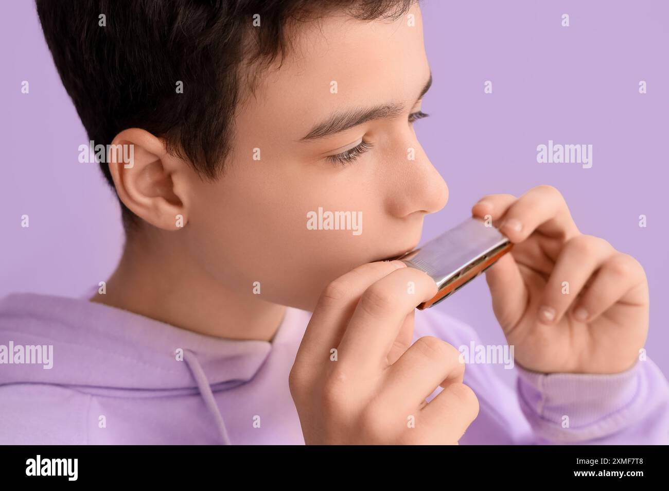 Boy playing harmonica hi-res stock photography and images - Alamy