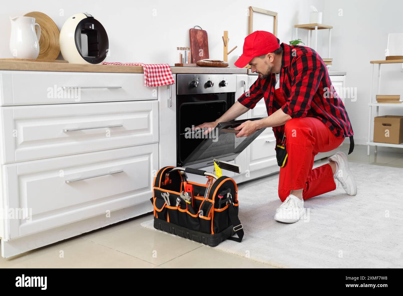 Handyman in uniform checking kitchen hi-res stock photography and ...