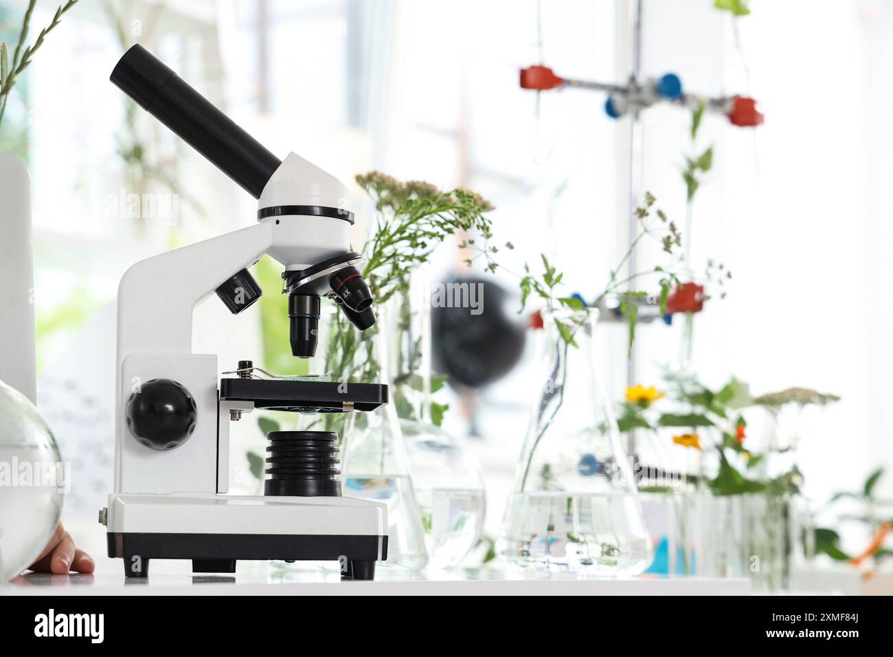 Modern microscope on table in Biology classroom, closeup Stock Photo ...