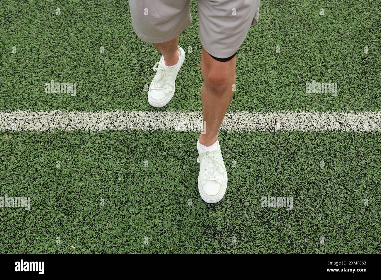 Man walking over starting line on grass. Concept of new beginning Stock ...