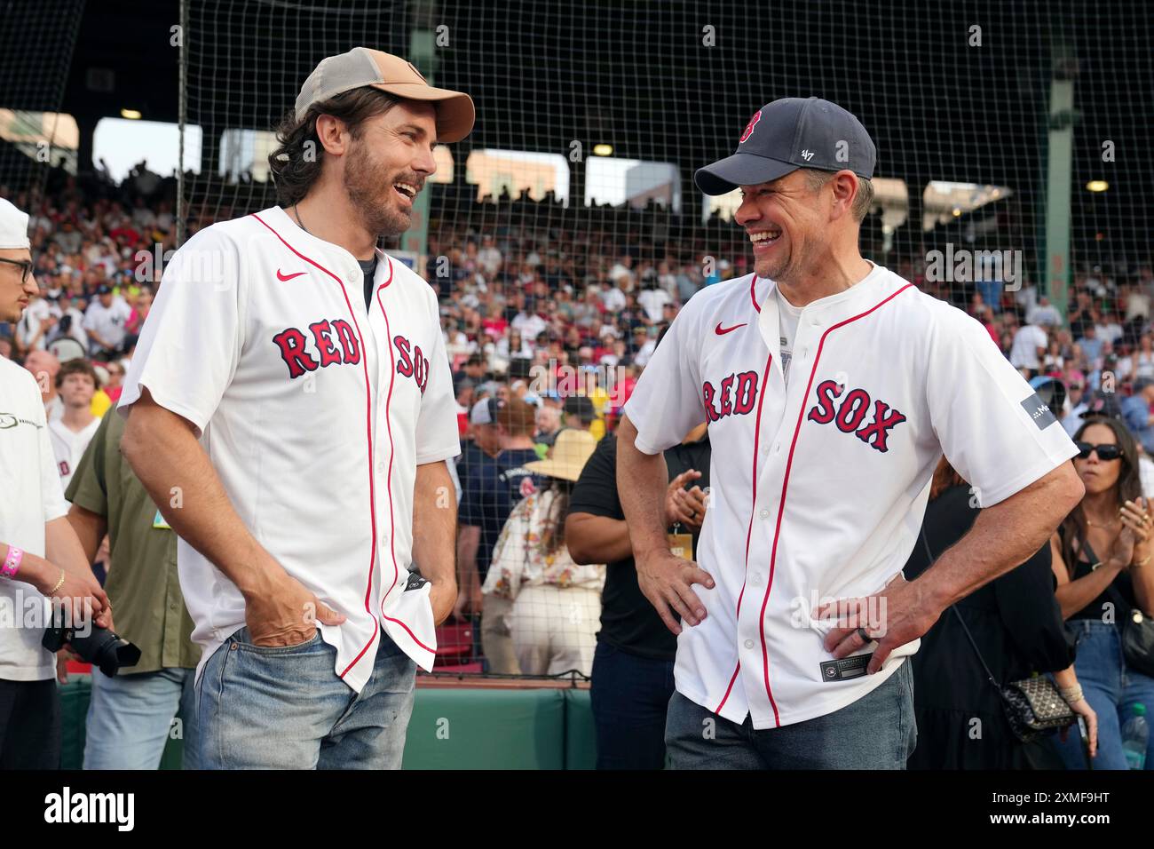 Matt Damon, right, and Casey Affleck stand on the field after throwing ...