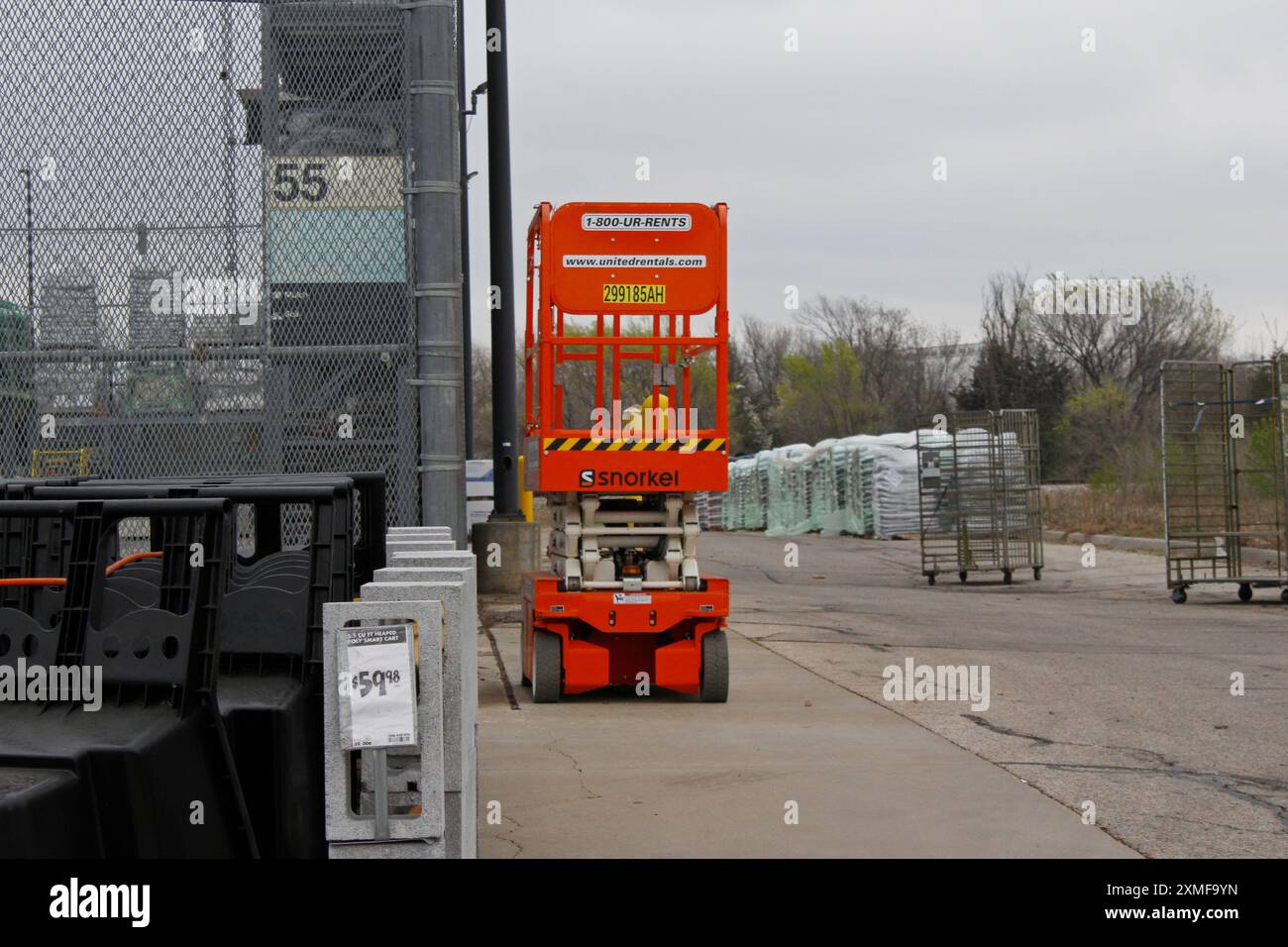 A Work Lift by a fence with blue sky outdoor Stock Photo - Alamy