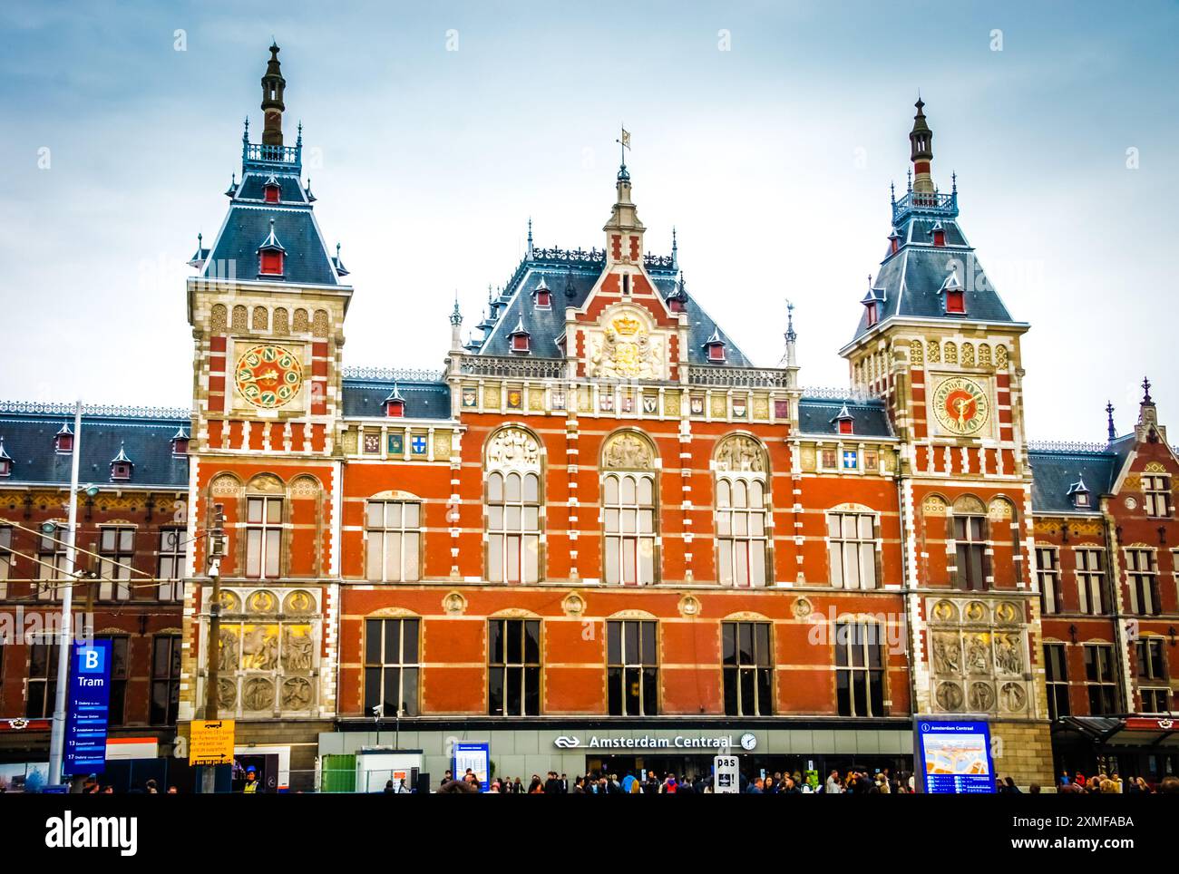 Amsterdam Centraal Station, a grand red brick building with a clock ...