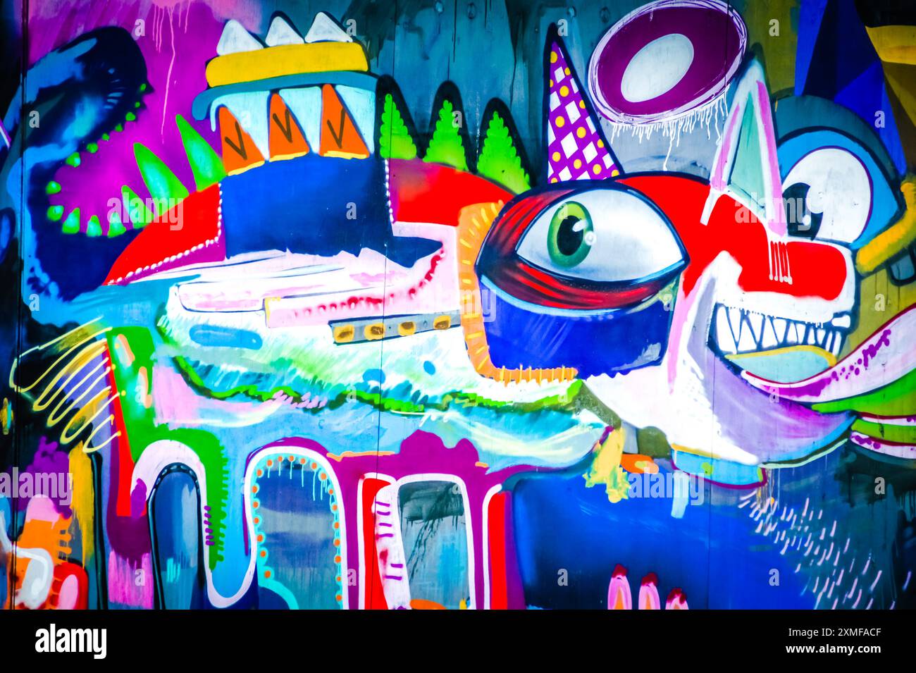 A colorful graffiti mural in Amsterdam depicts a friendly monster with ...