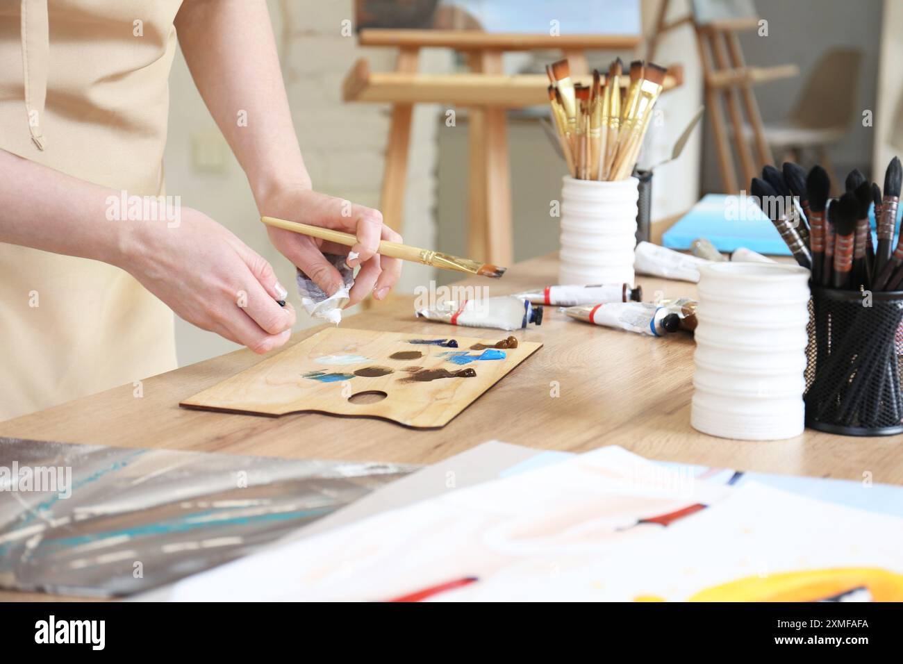 Female artist using brush painting hi-res stock photography and images ...