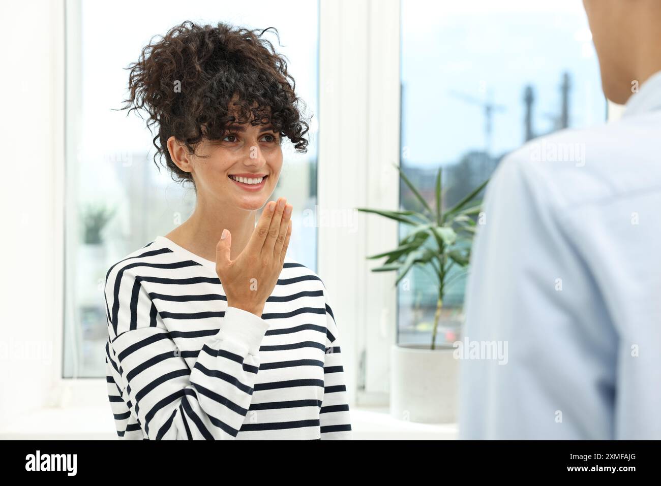 Man and woman using sign language for communication indoors Stock Photo ...