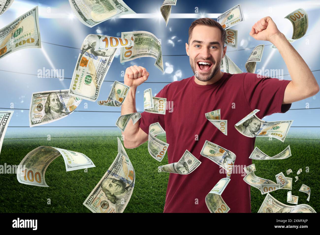 Happy man under money shower at stadium Stock Photo - Alamy