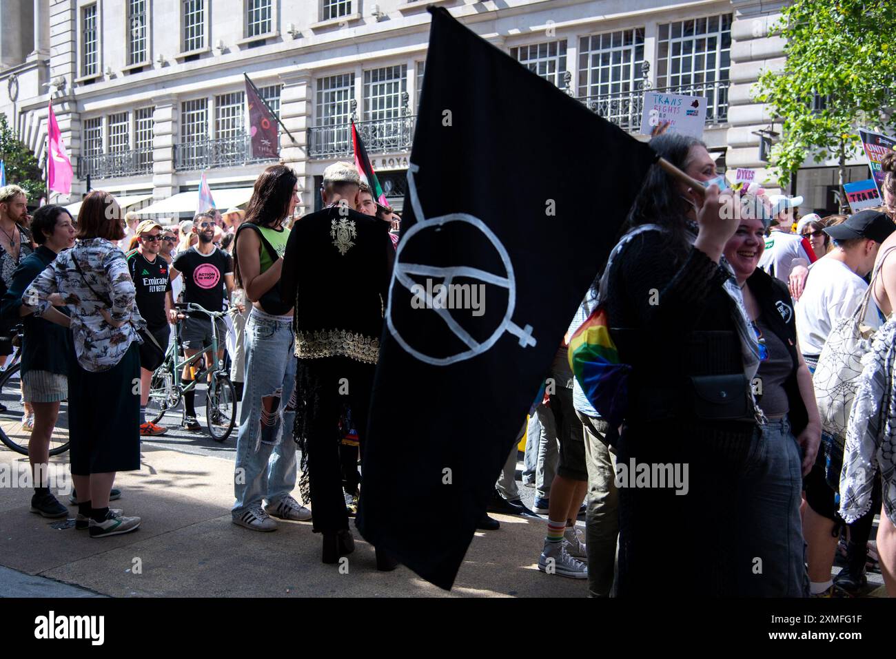 London, UK. 27th July, 2024. A participant marches with the anarchy ...