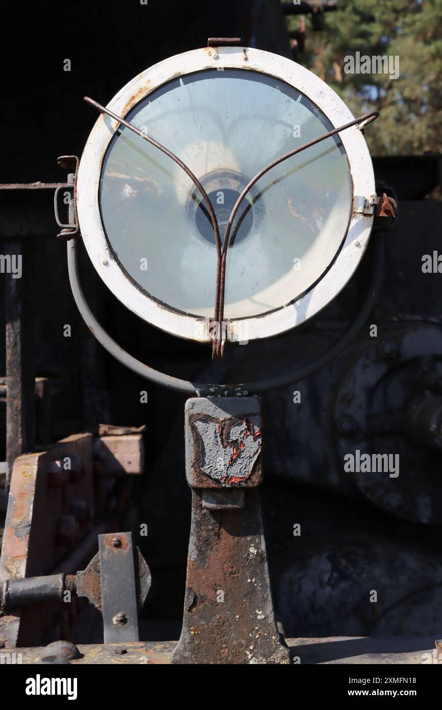 Close-up vertical photo of a spotlight lamp from an old, abandoned ...