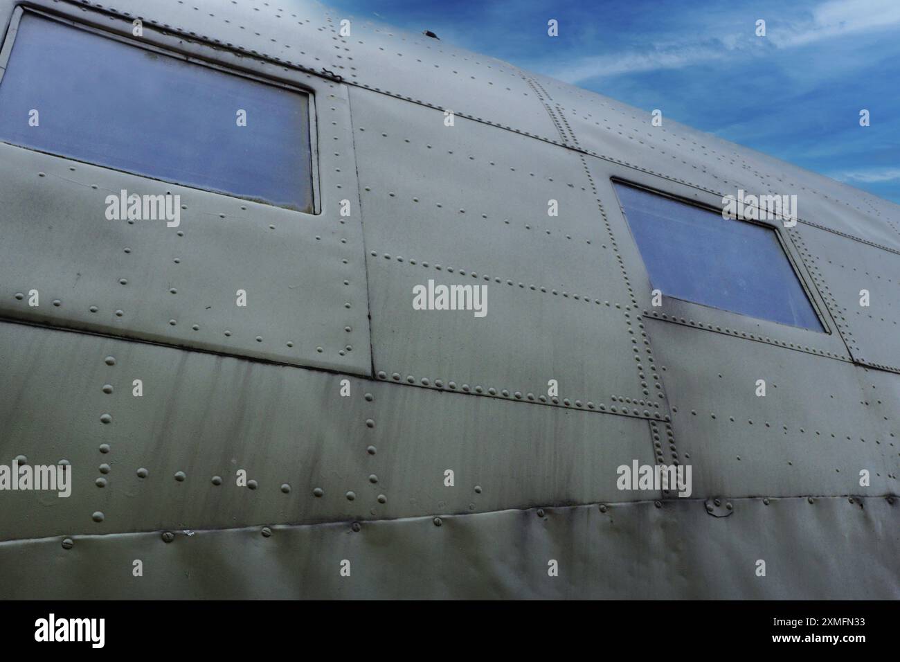 Airplane surface with two windows and illuminators, metal cladding with ...