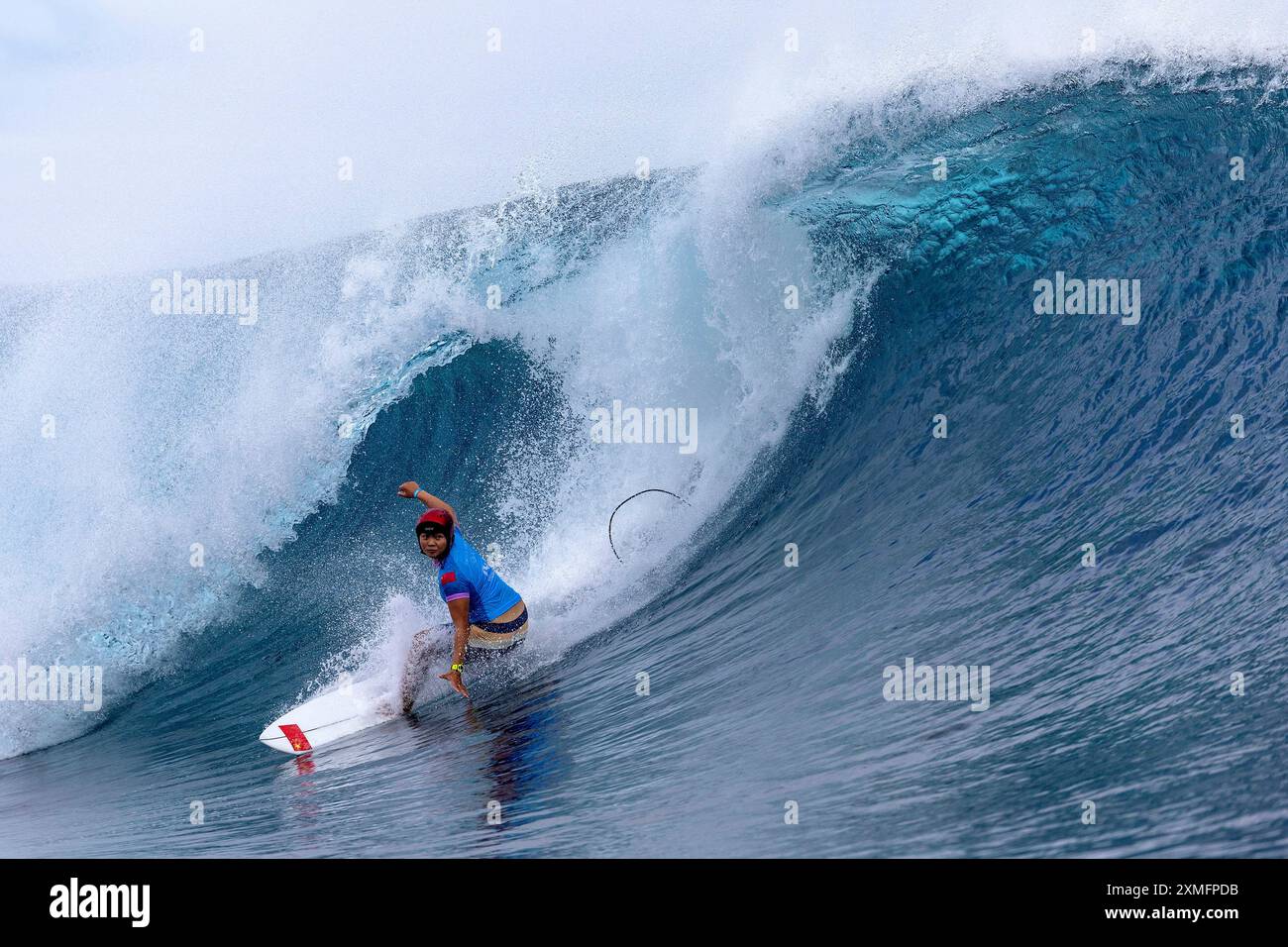 Yang Siqi of China rides a wave during round one of surfing on day one ...