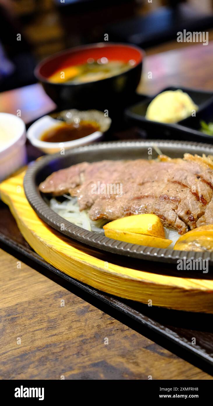 The vertical Japanese food sliced teppanyaki set dinner meal with soup ...