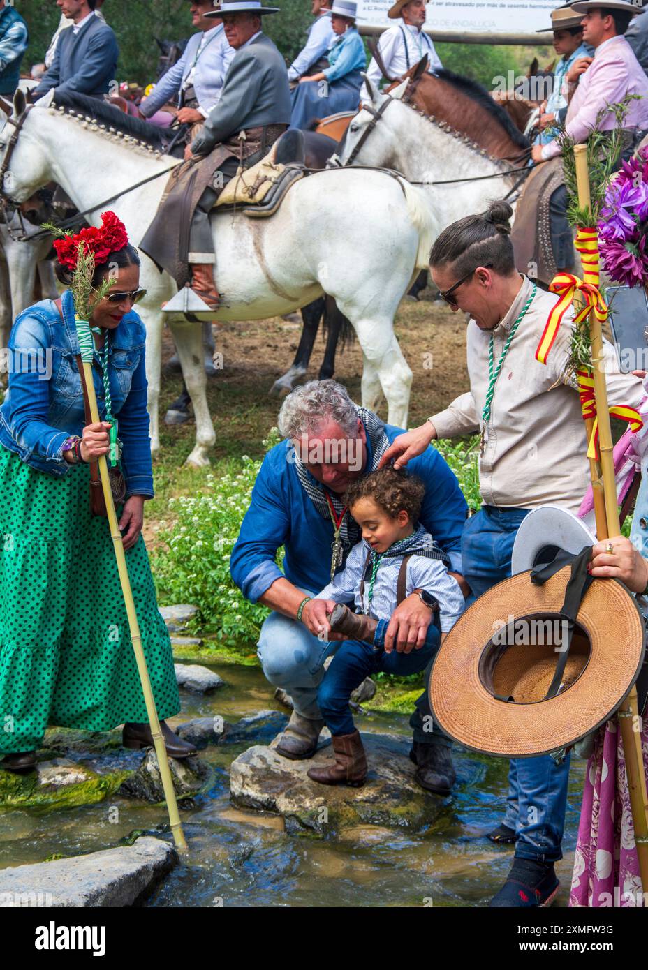 Baptism of a child surrounded by his family during the celebration of ...