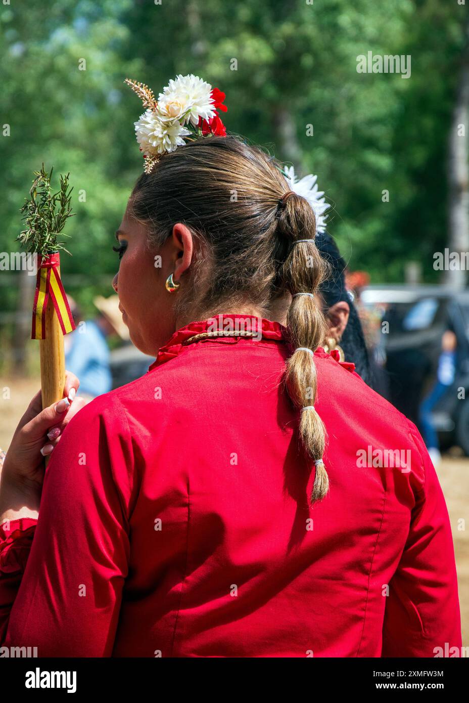 Woman turned wearing the typical "rociero" costume and flowers in her ...
