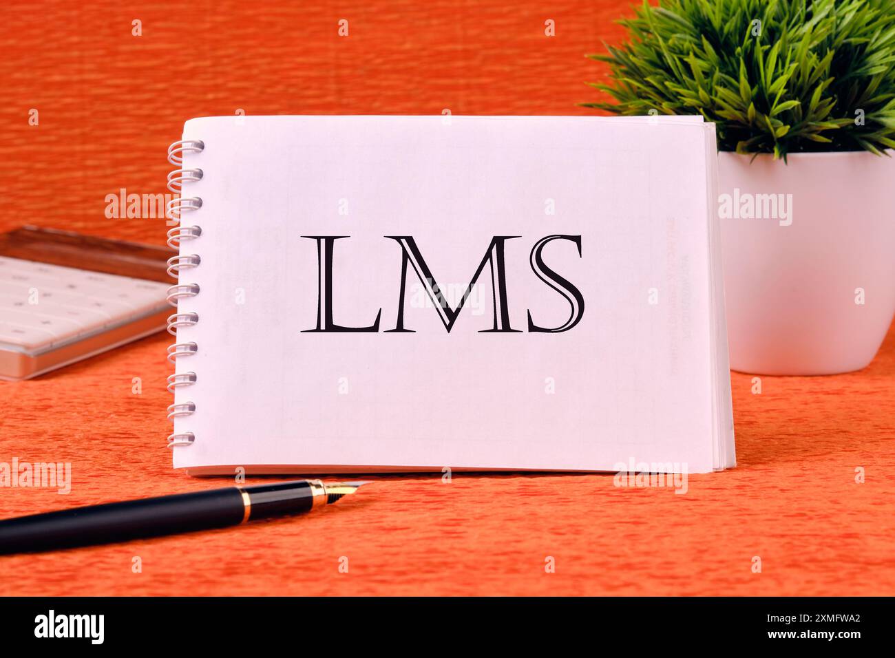 LMS stands for Learning Management System. LMS word on a white notebook on an orange background ...