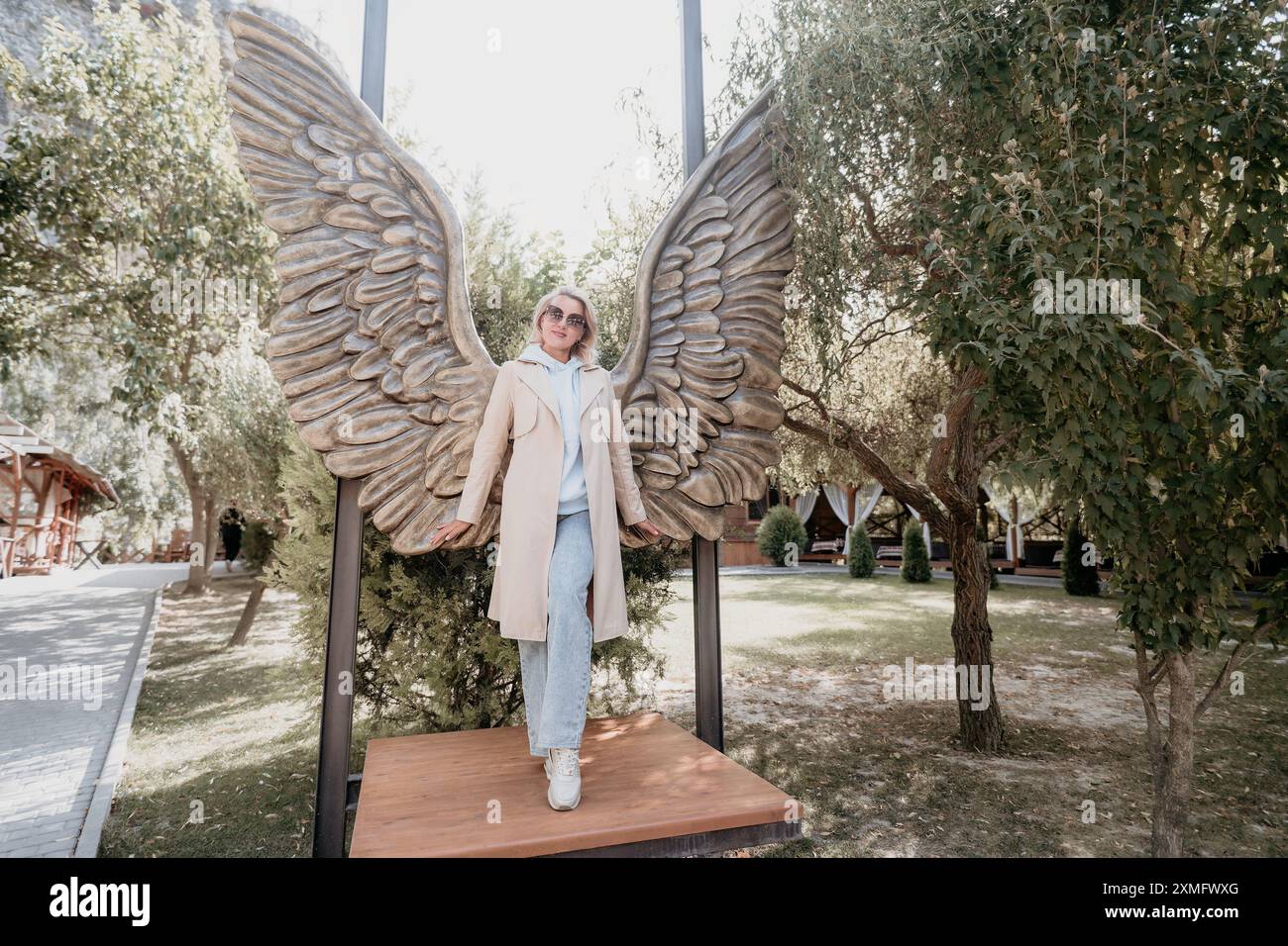 Woman Standing Between Angel Wings Stock Photo - Alamy