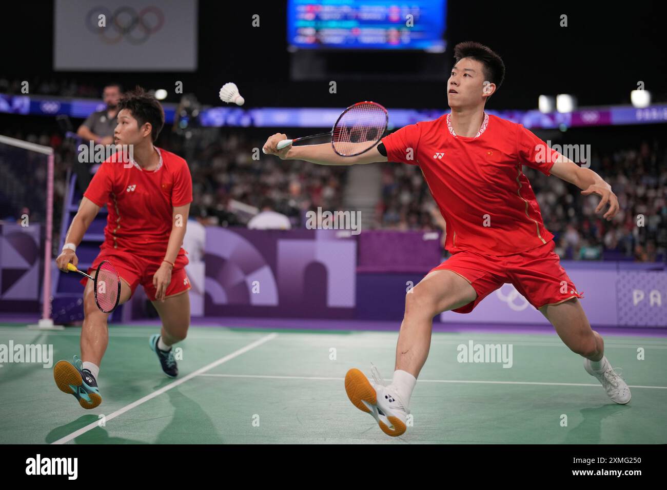 China's Feng Yan Zhe, right, and Huang Dong Ping play against Singapore ...