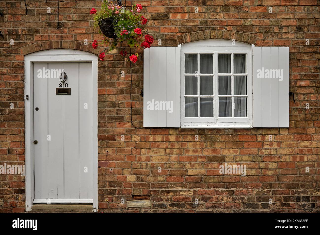 Traditional English cottage frontage with shuttered panelled window ...