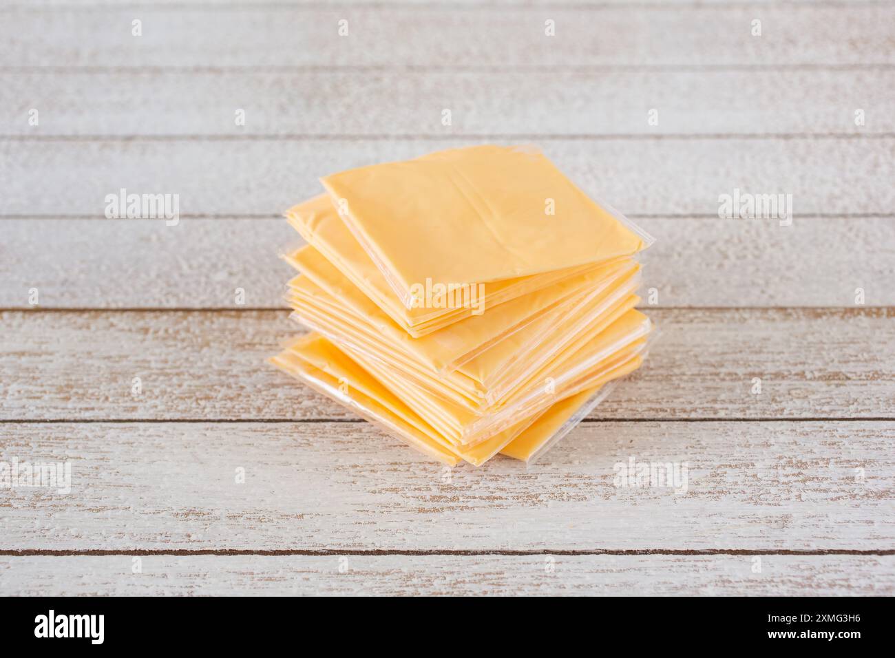 A view a stack of processed cheese slices, individually wrapped in ...