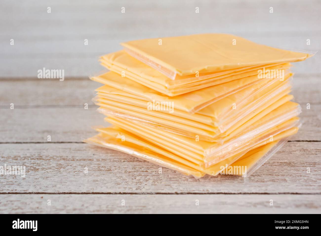 A view a stack of processed cheese slices, individually wrapped in ...