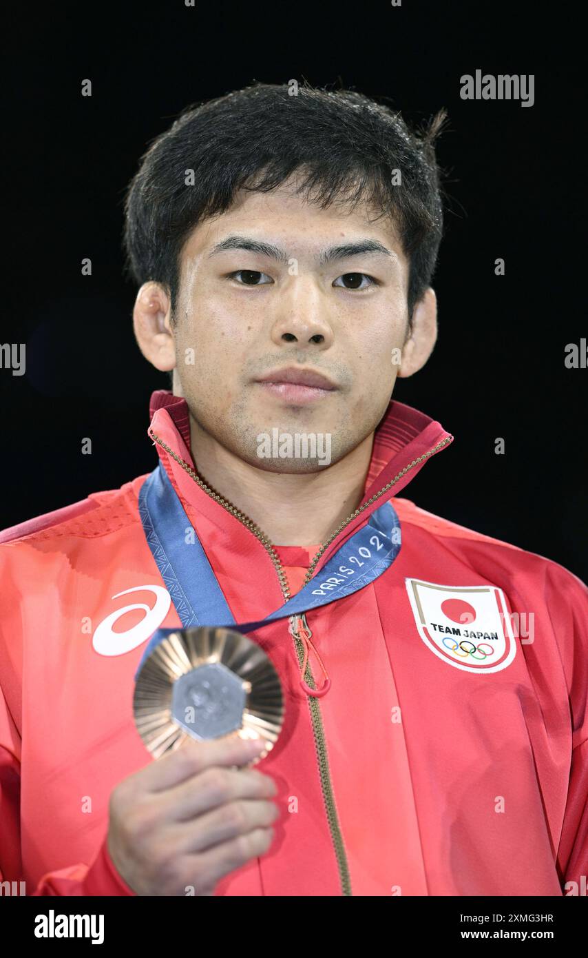 Japan's Ryuju Nagayama poses with his bronze medal for the men's judo ...
