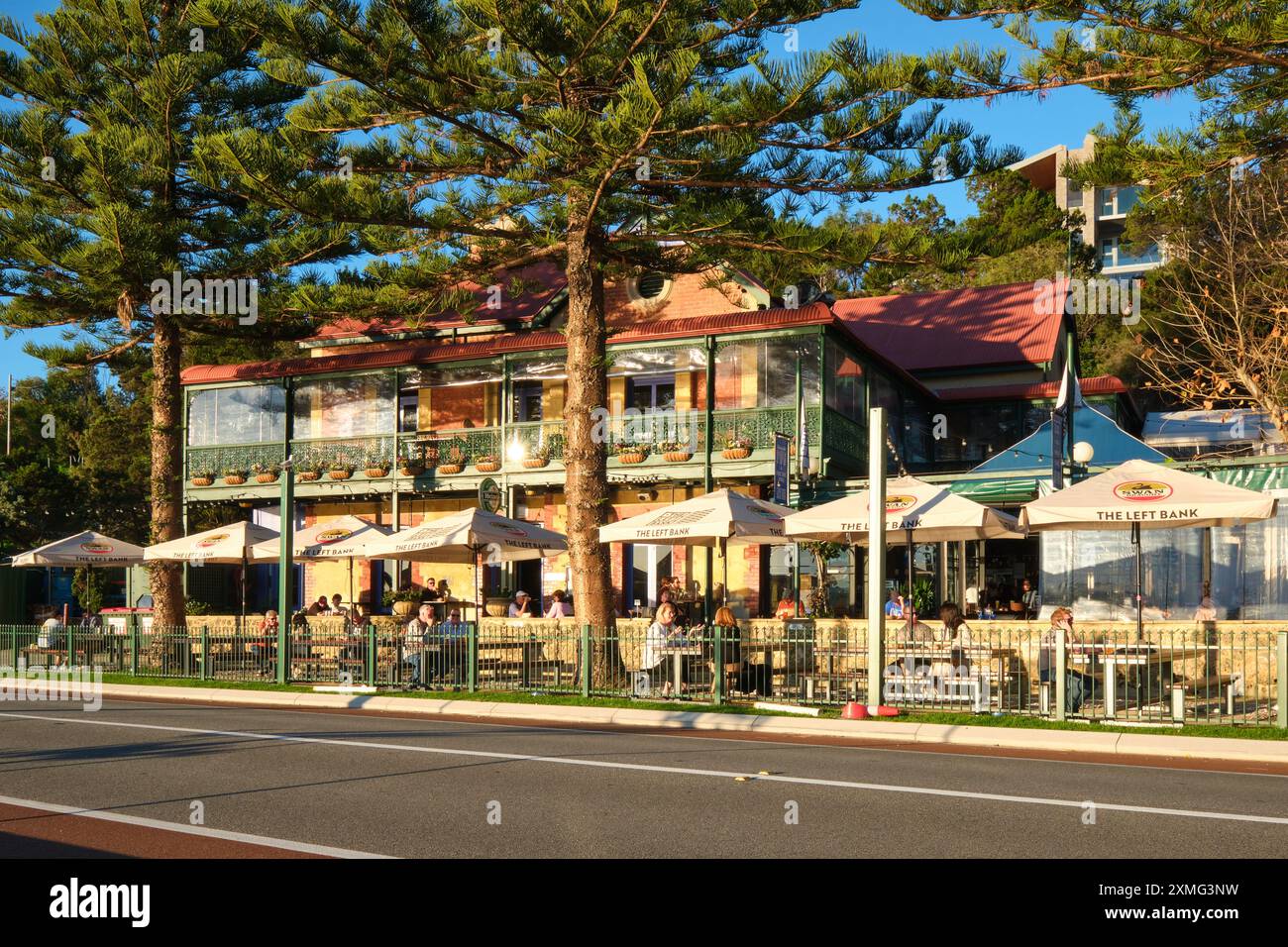People socialising and drinking in the beer garden at the Left Bank ...