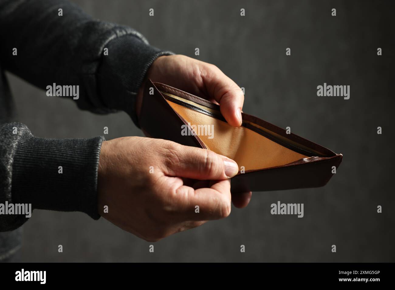 Man with empty wallet on dark background, closeup Stock Photo - Alamy