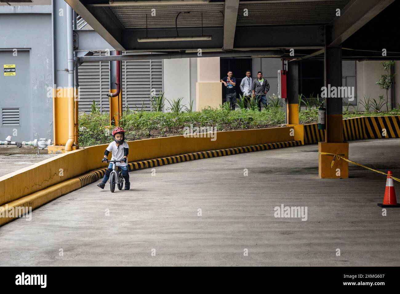Iloilo City, Philippines. 28th July, 2024. A kid warms up before his push bike race at a bike ...