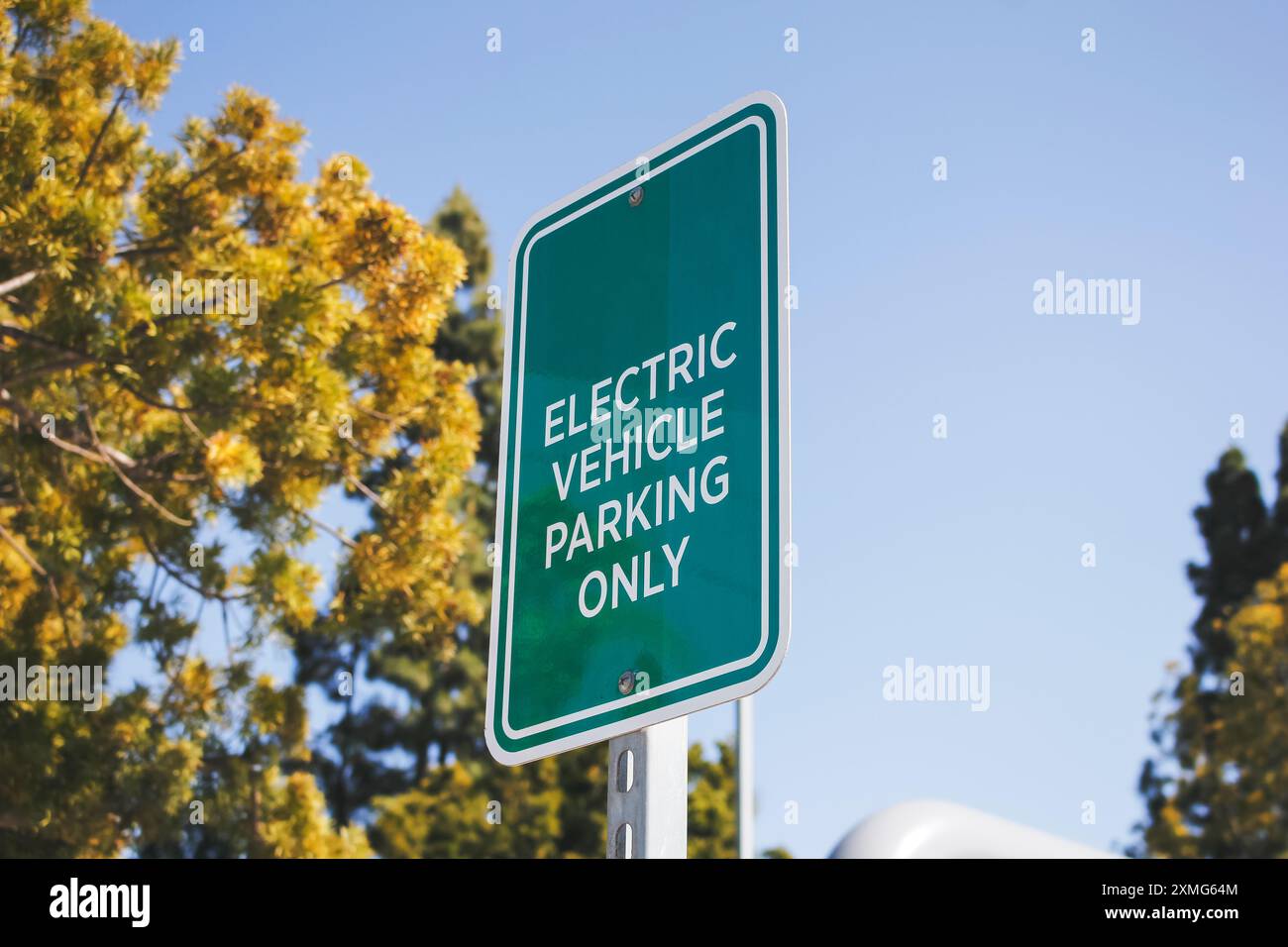 A view of an electric vehicle parking only sign Stock Photo - Alamy